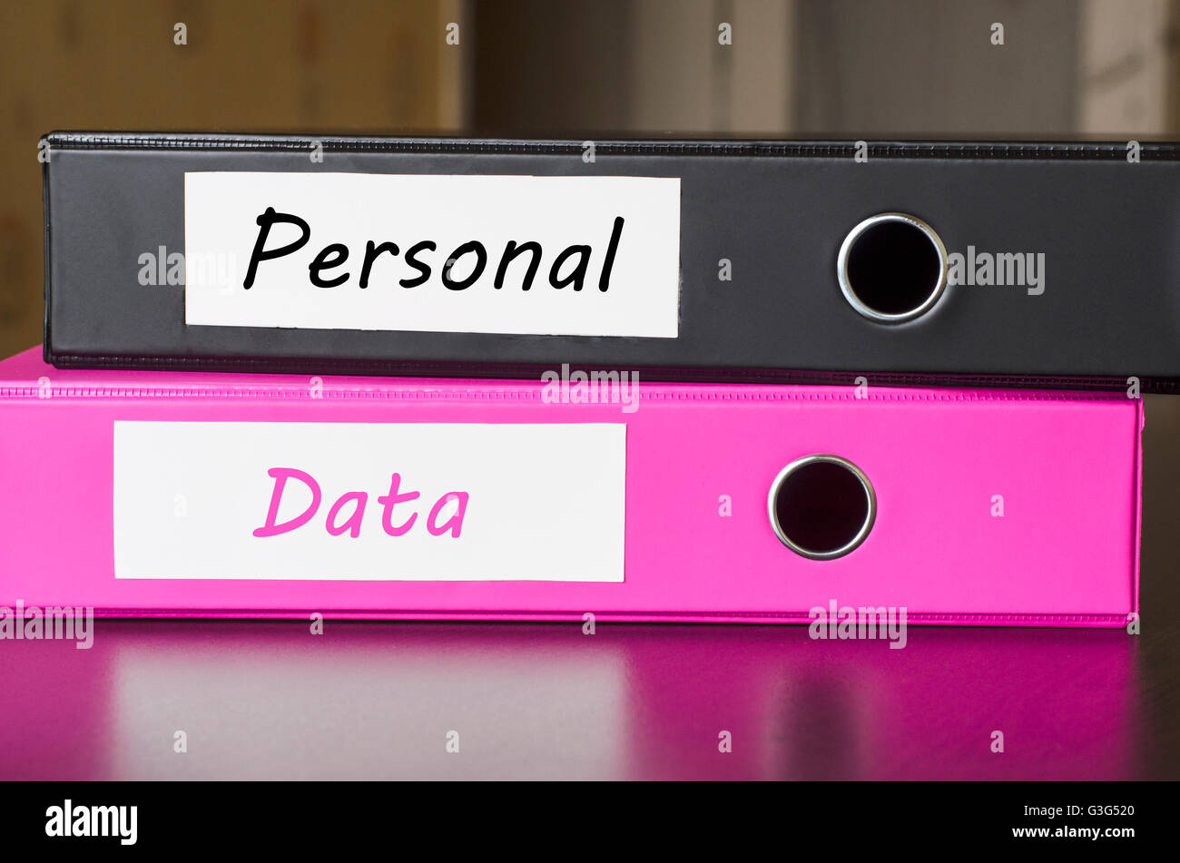 Bright office folders over dark background and personal data text ...