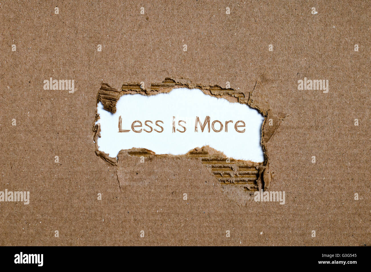 The word less is more appearing behind torn paper Stock Photo - Alamy