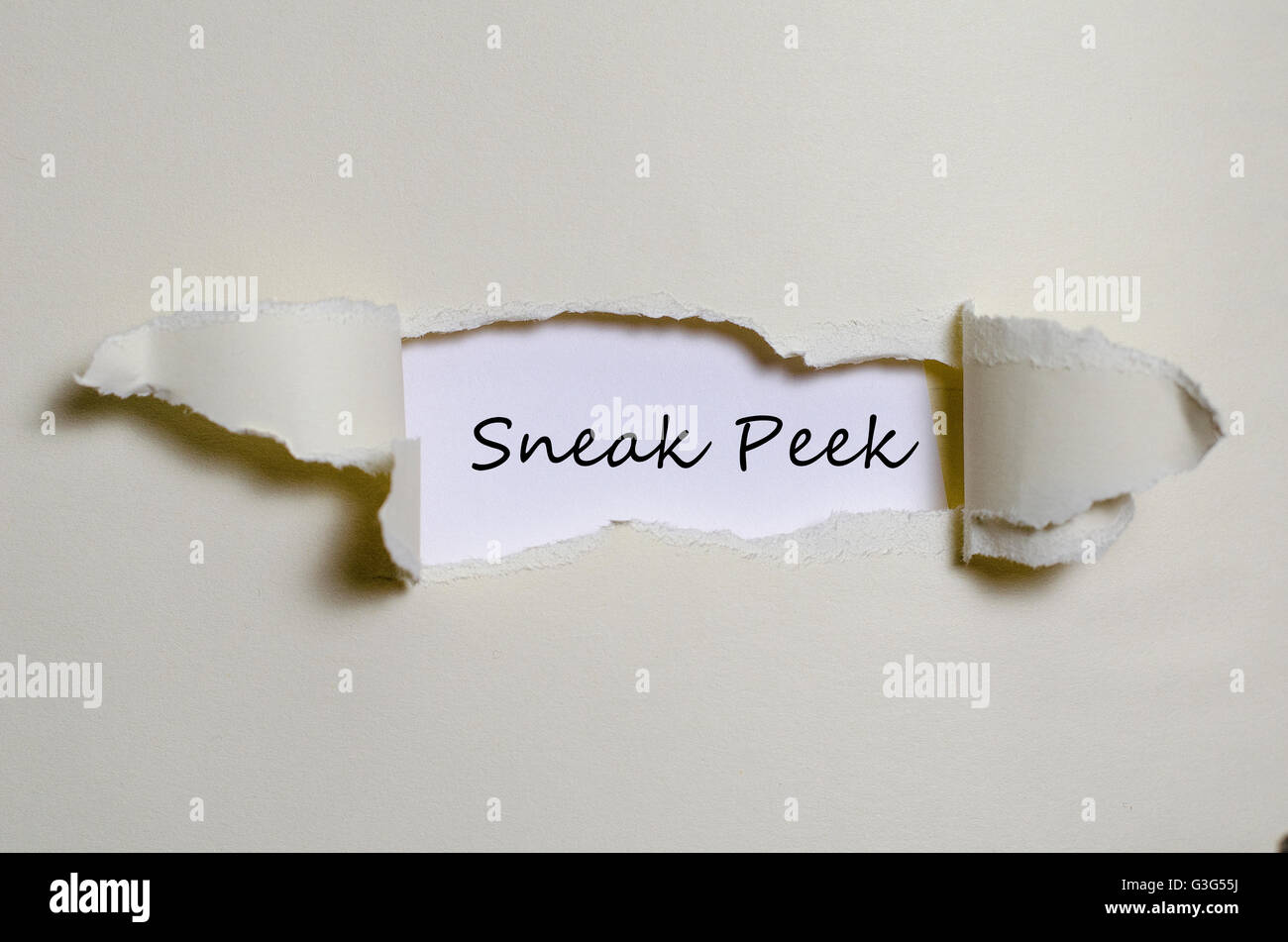 The word sneak peek appearing behind torn paper Stock Photo - Alamy