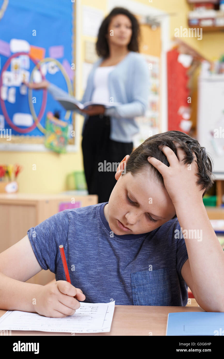 Male Elementary School Pupil Struggling In Class Stock Photo - Alamy