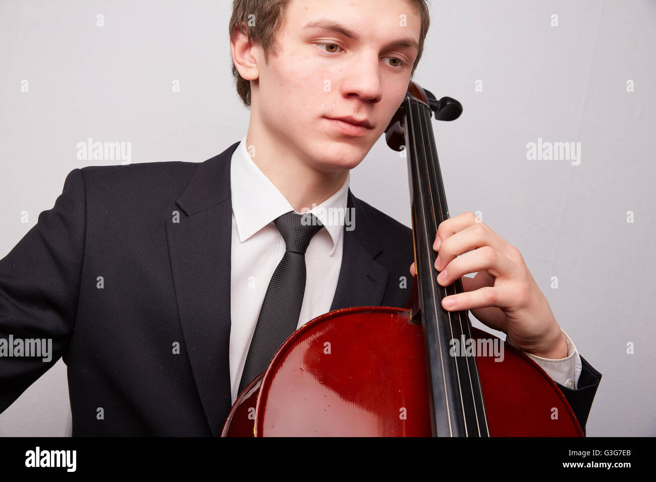 young man with a cello Stock Photo - Alamy