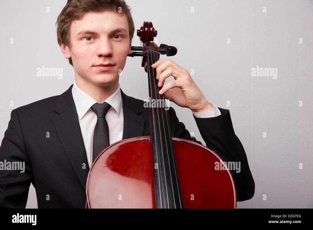 young man with a cello Stock Photo - Alamy