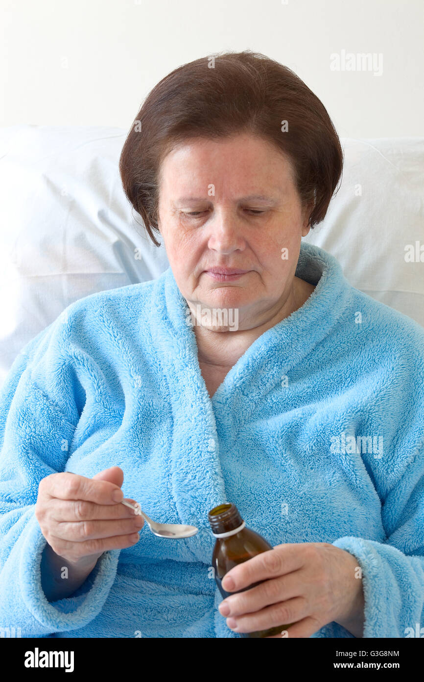 Senior woman with syrup Stock Photo - Alamy