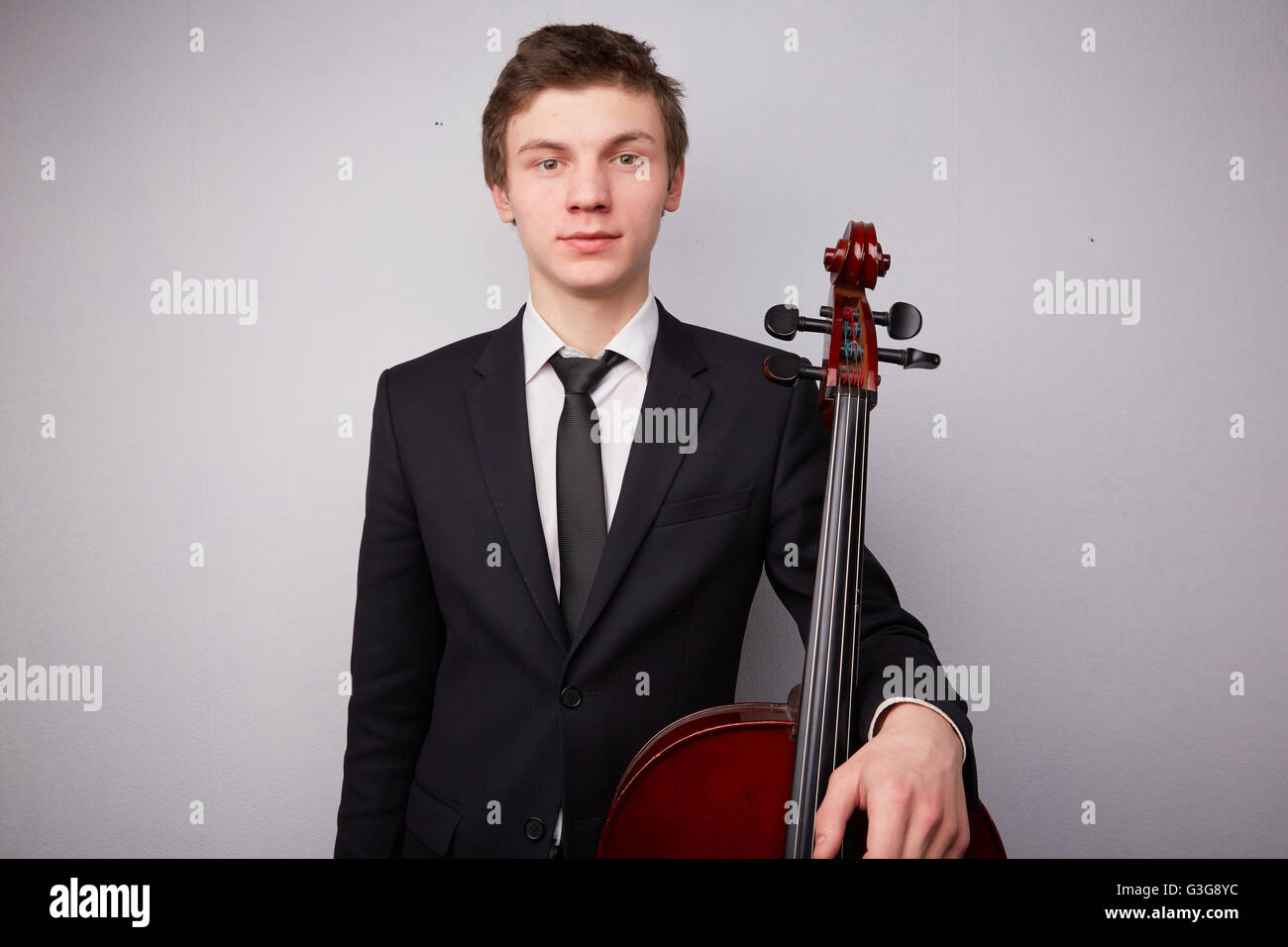 young man with a cello Stock Photo - Alamy