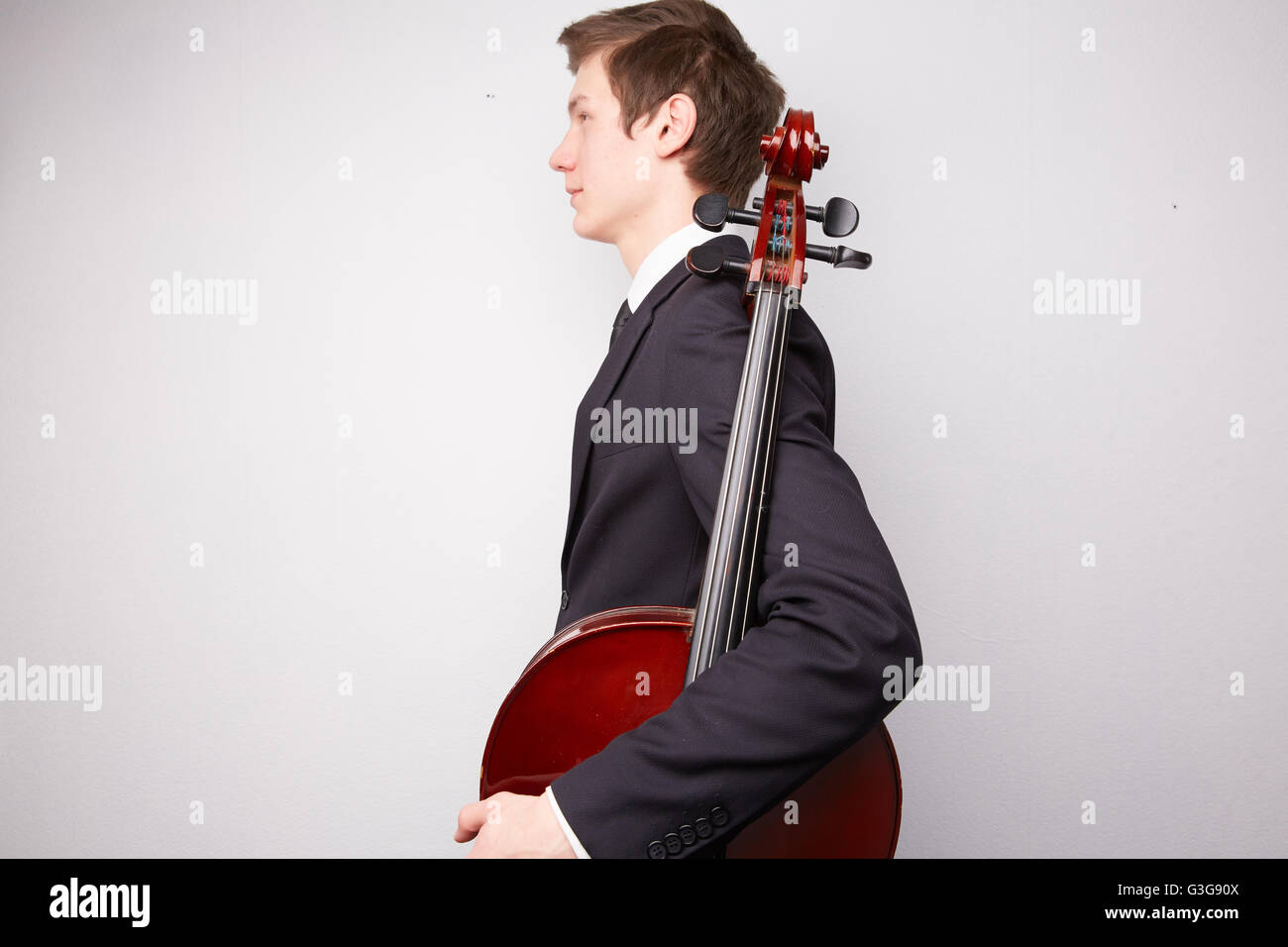 young man with a cello Stock Photo - Alamy