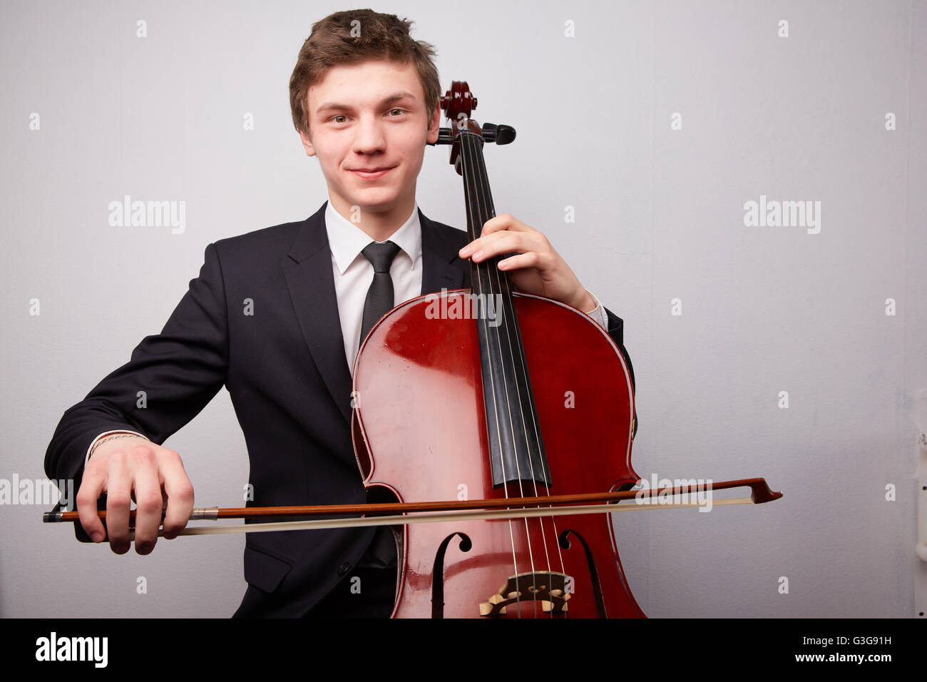 young man with a cello Stock Photo - Alamy
