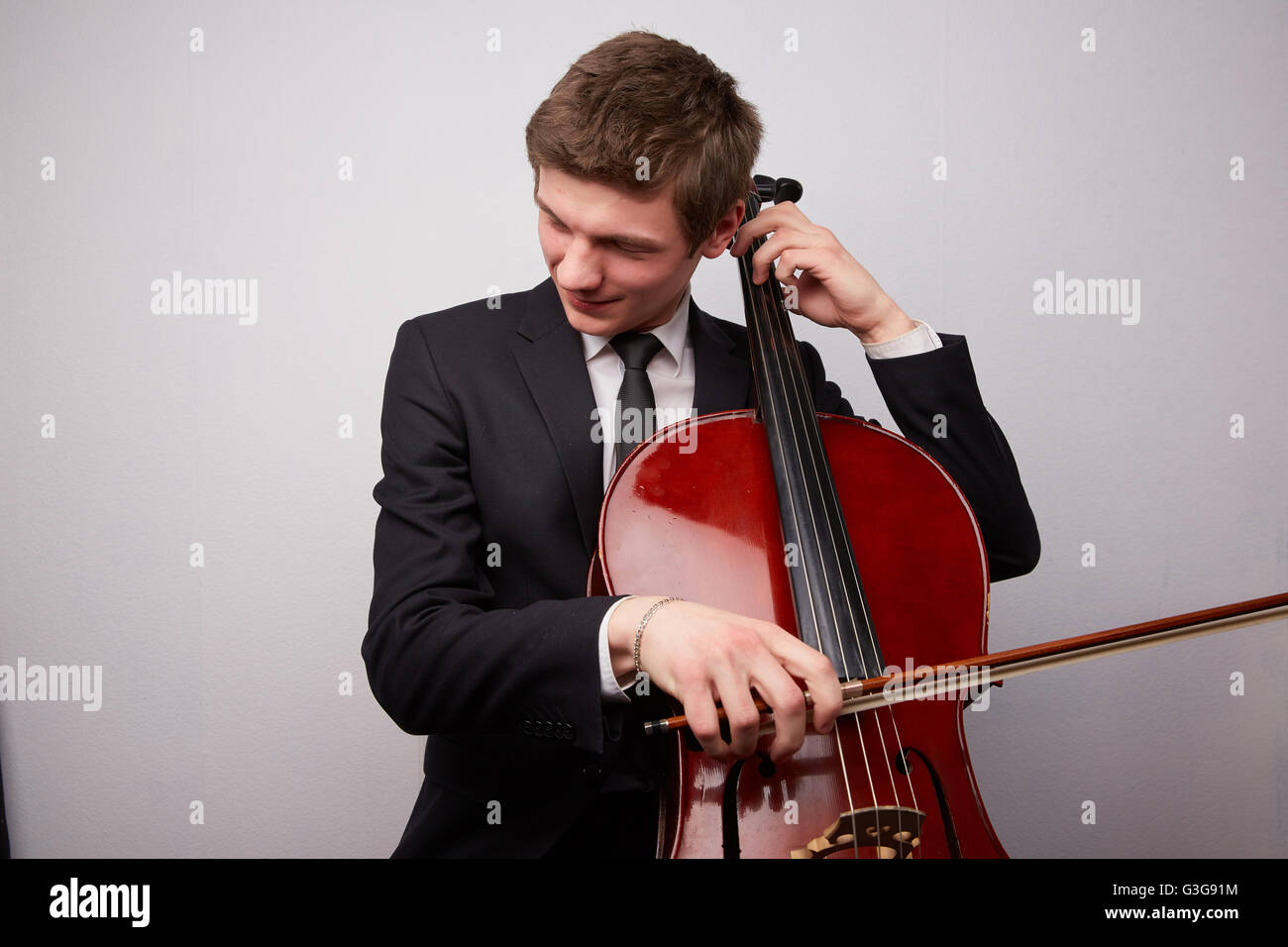 young man with a cello Stock Photo - Alamy