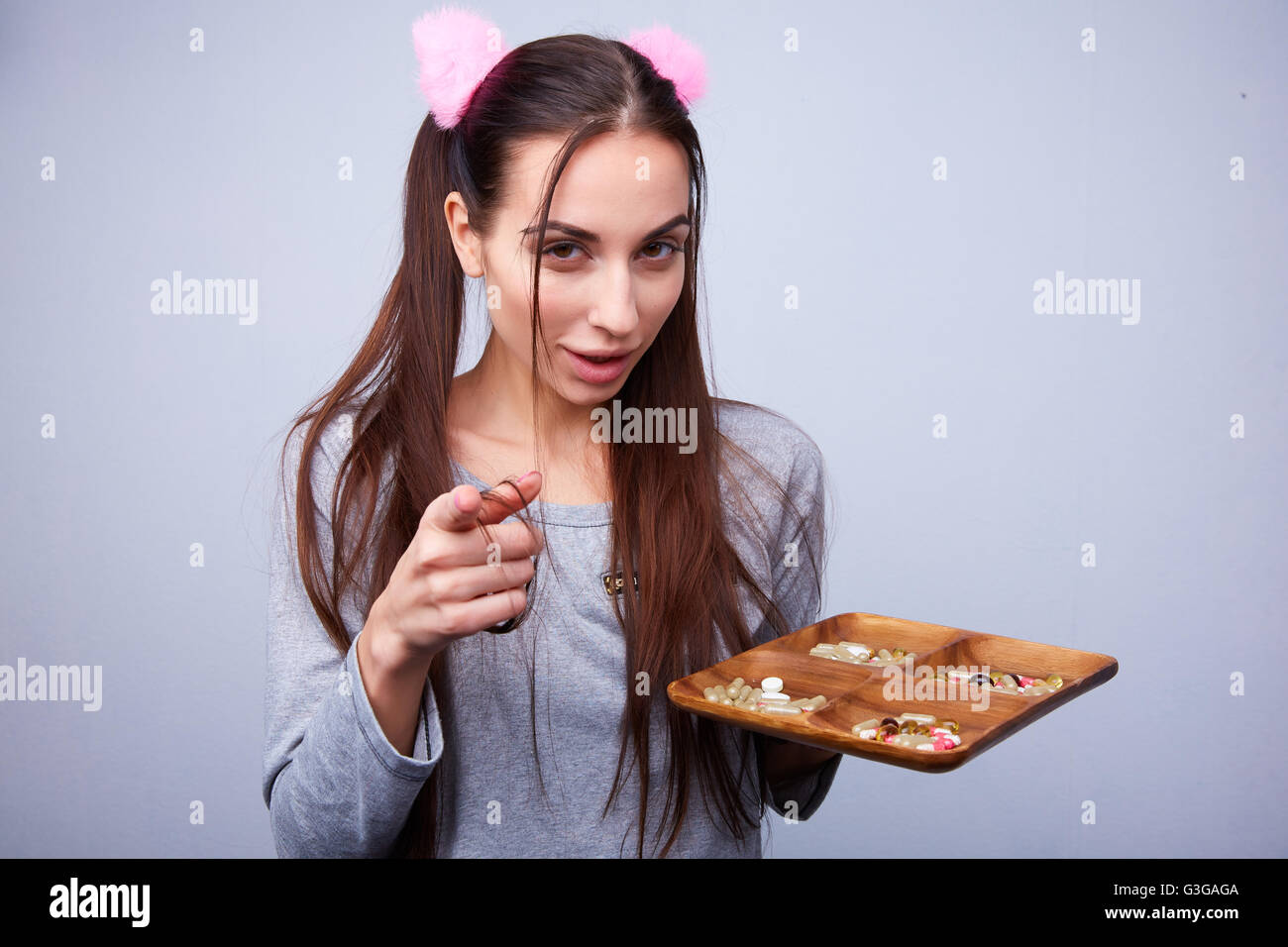 fun girl drinks a lot of pills Stock Photo - Alamy