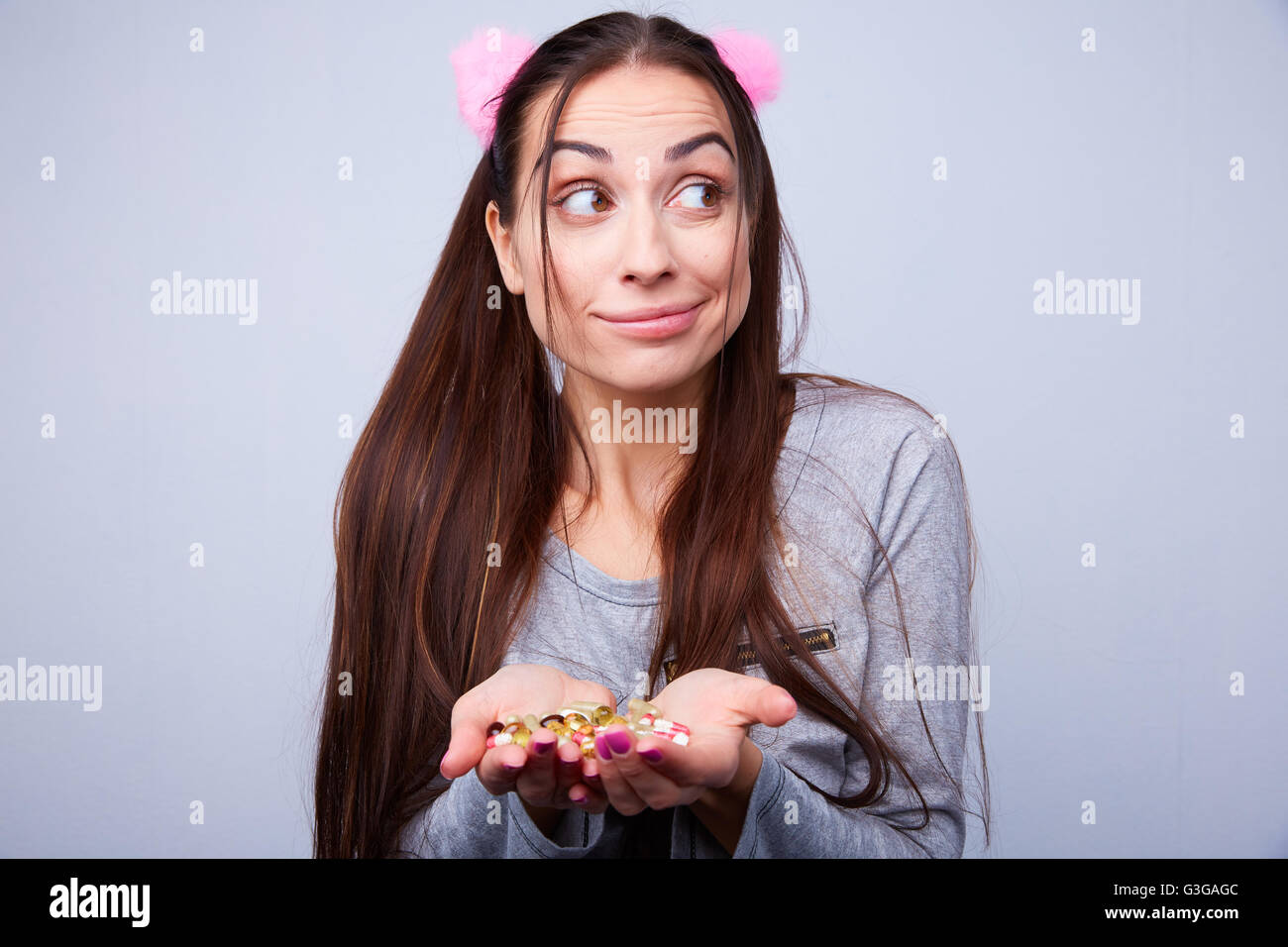 fun girl drinks a lot of pills Stock Photo - Alamy