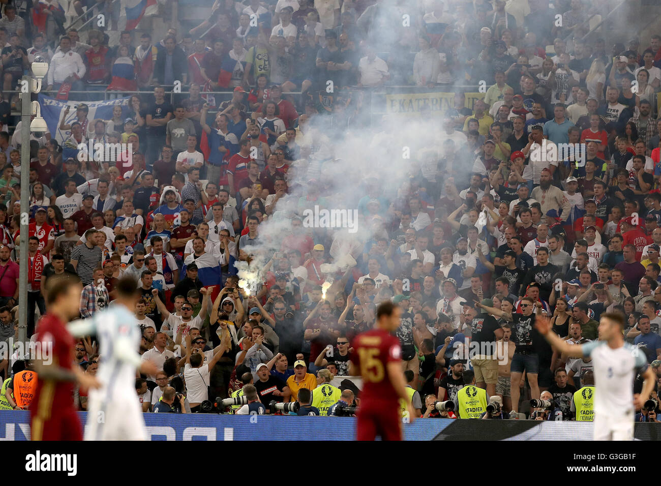 Flares are let off by a fan in the stands during the UEFA Euro 2016 ...
