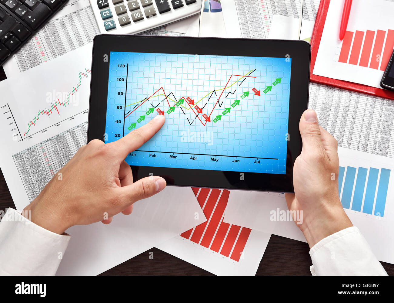 hands using digital tablet with stock chart on screen Stock Photo - Alamy