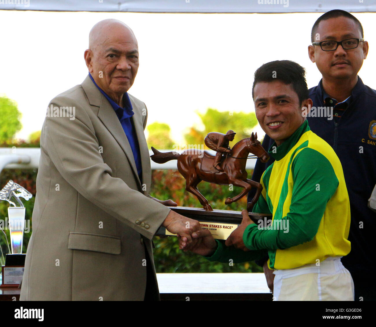 PHILRAMCO Commissioner Andrew Sanchez (left) awarded the trophy to ...
