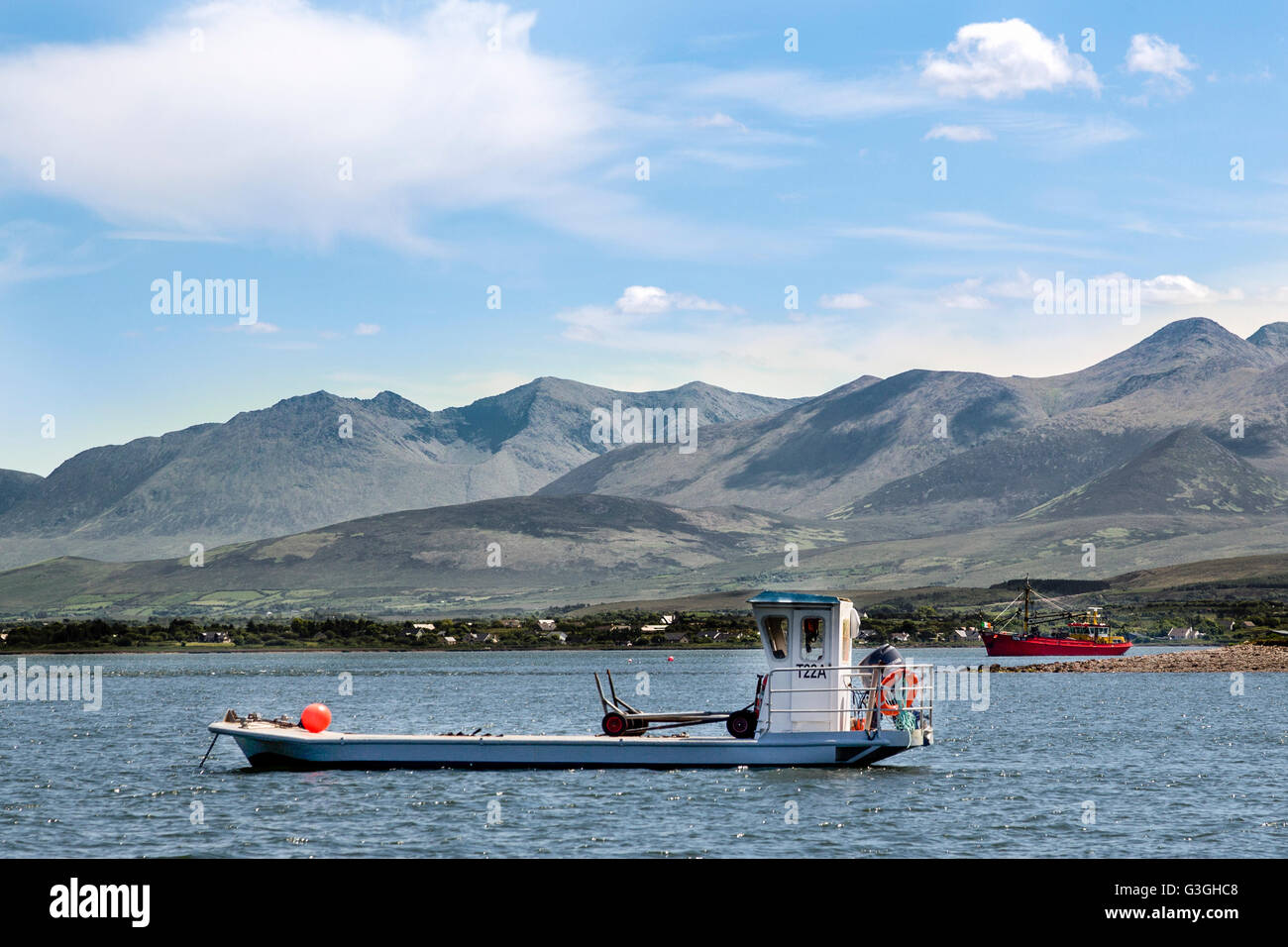 Flat bottomed oyster boat and fishing trawler in Cromane Harbour ...