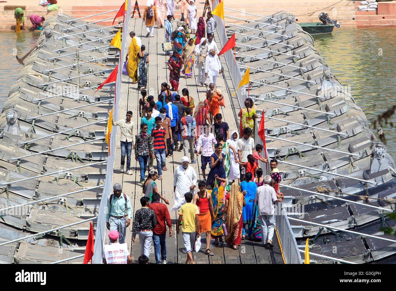 Hindu devotees cross temporary pontoon bridge during Simhastha Kumbha ...