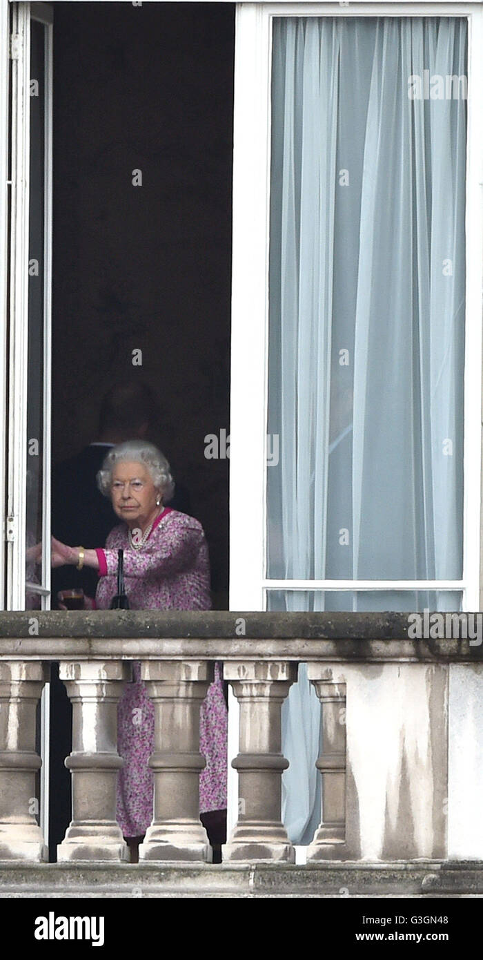 Queen Elizabeth II looks out from the window at Buckingham Palace ...