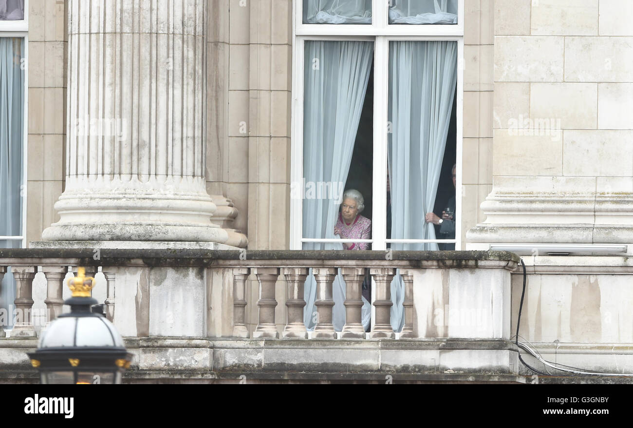 Queen Elizabeth II looks out from the window at Buckingham Palace ...
