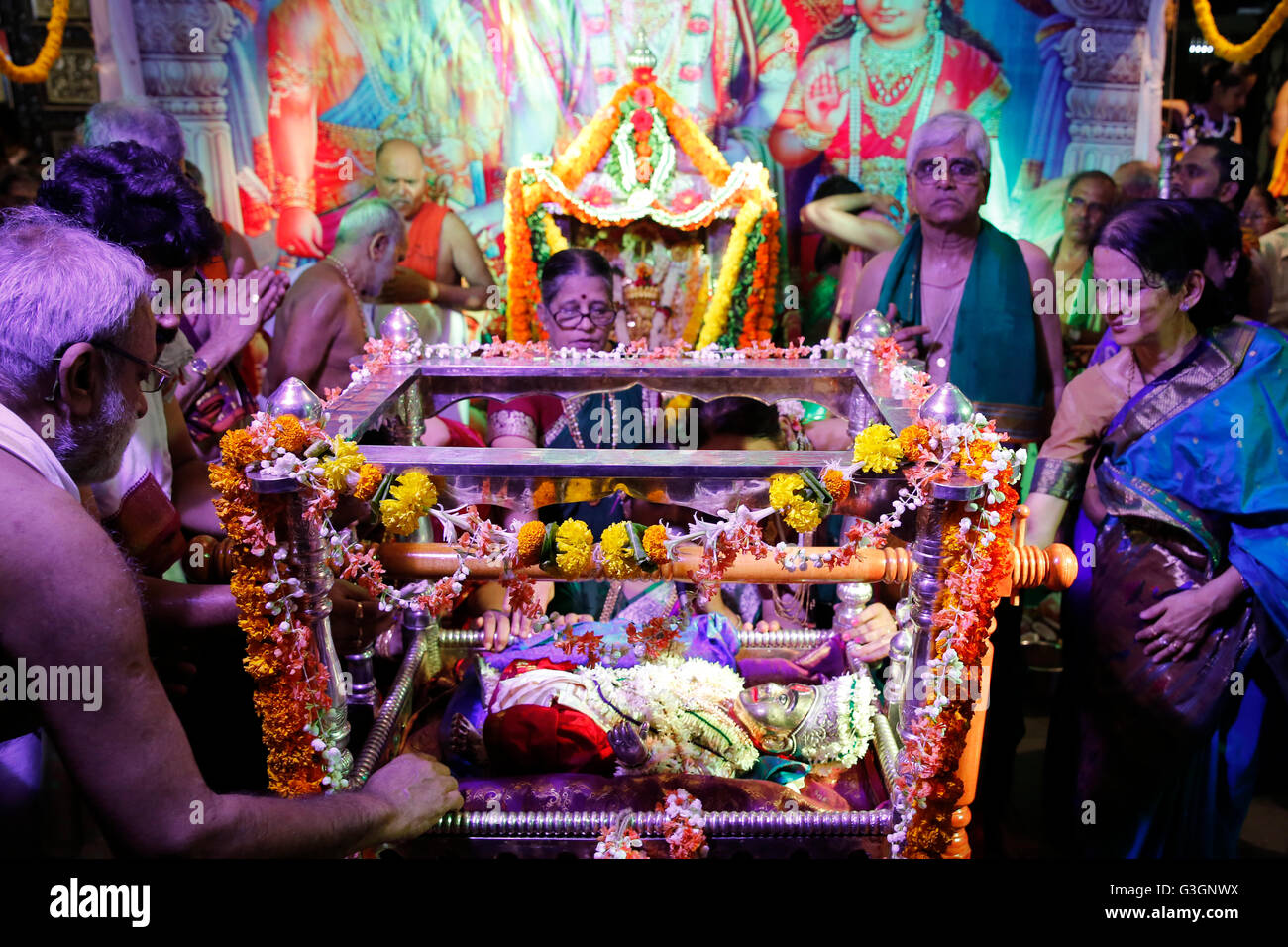 Mumbai, India. 16th Apr, 2016. Priests sing prayers to an idol of Hindu ...