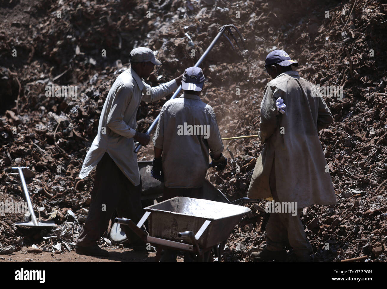 Pakistani blacksmiths work at an iron molding factory in an industrial ...