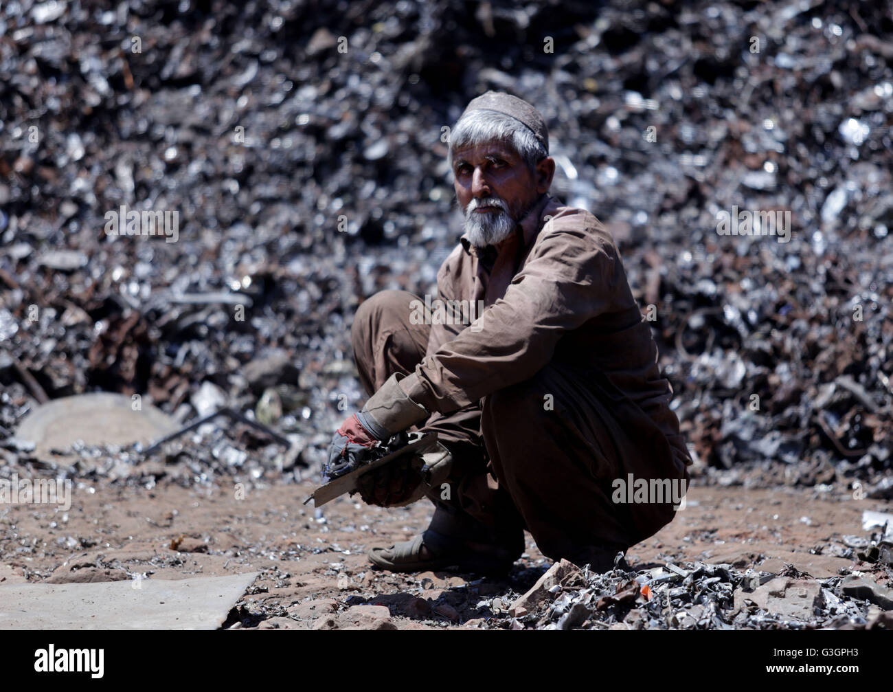 Pakistani blacksmiths work at an iron molding factory in an industrial ...