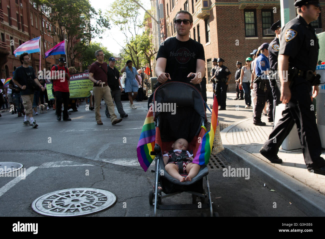 New York, USA. 24th June 2016. Man conveys baby in a stroller with gay ...