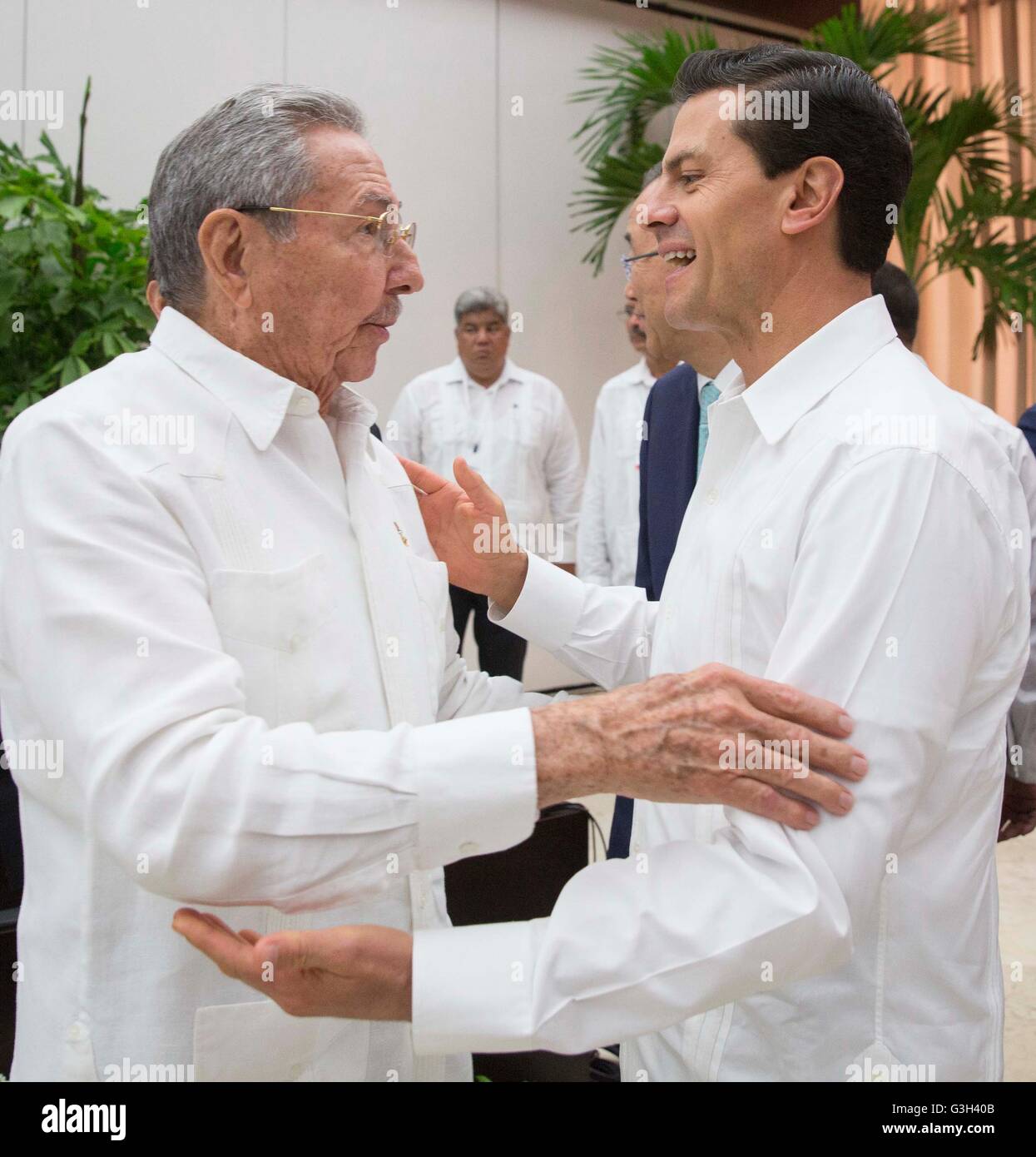 Mexican President Enrique Pena Nieto shakes hands with Cuban leader ...