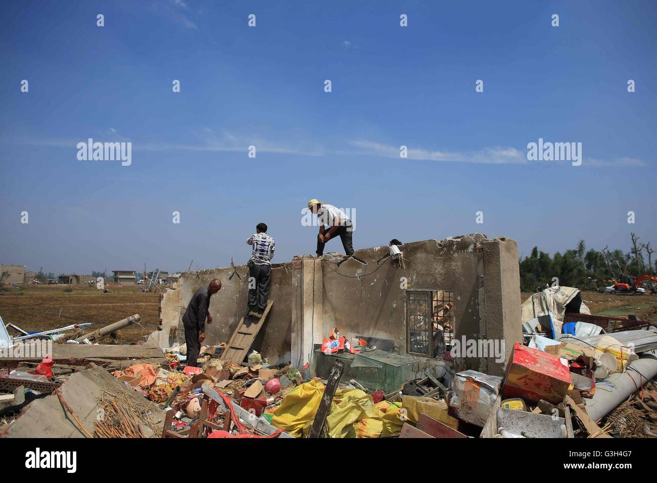 Yancheng, China's Jiangsu Province. 25th June, 2016. Villagers clear up ...