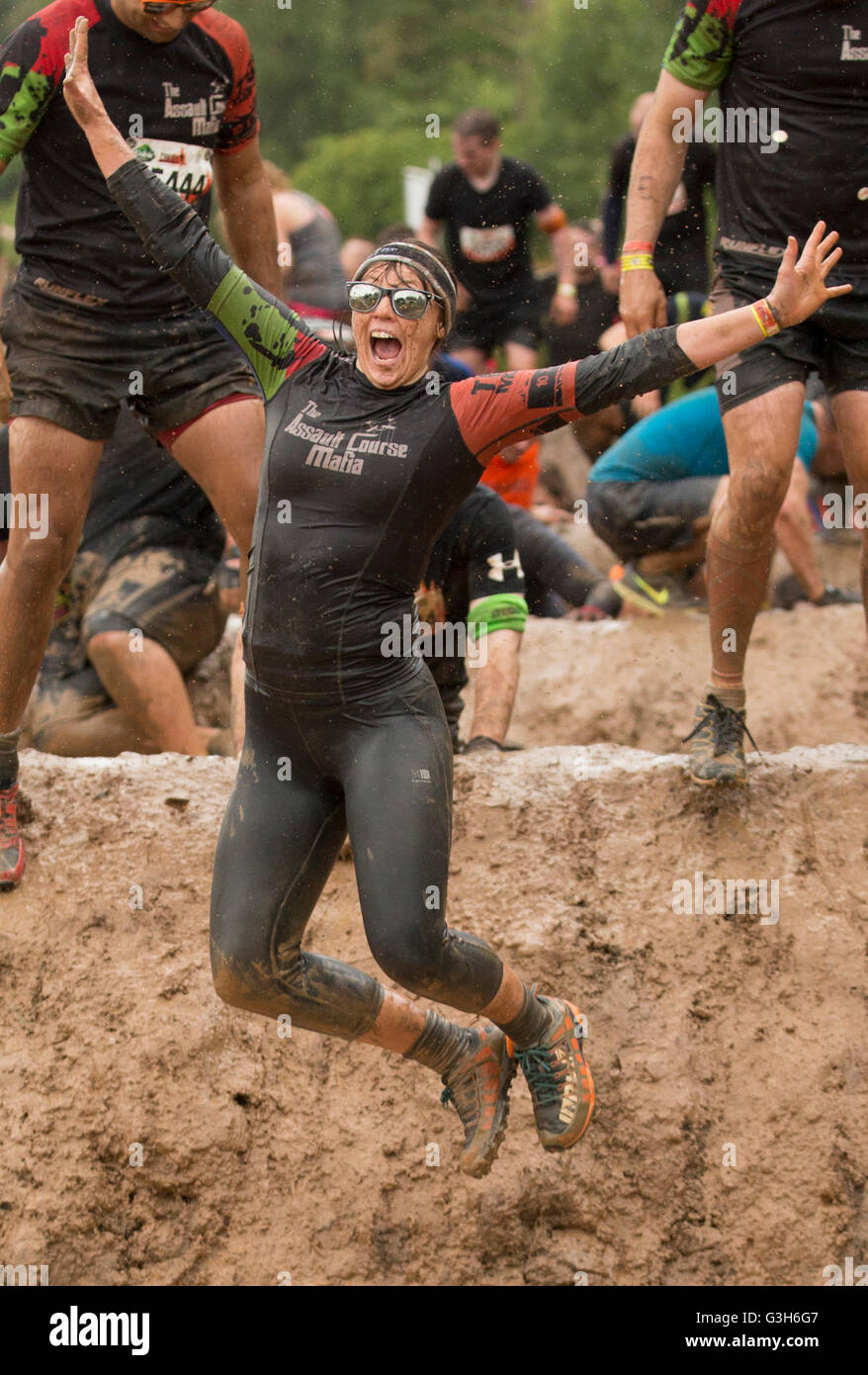 Jumping into muddy puddle on the Mile of Mud obstacle, Tough Mudder at ...