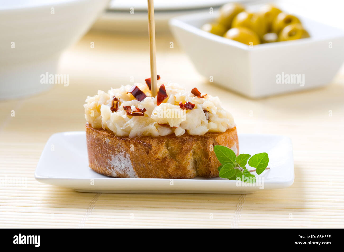 Spanish tapa called pincho with cod and chili pepper Stock Photo - Alamy