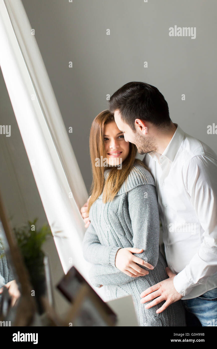 Loving couple by the window Stock Photo - Alamy