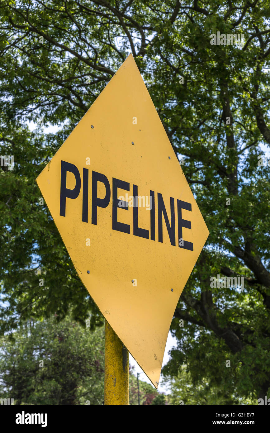 Yellow warning pipeline sign - as visual metaphor for concept of ...