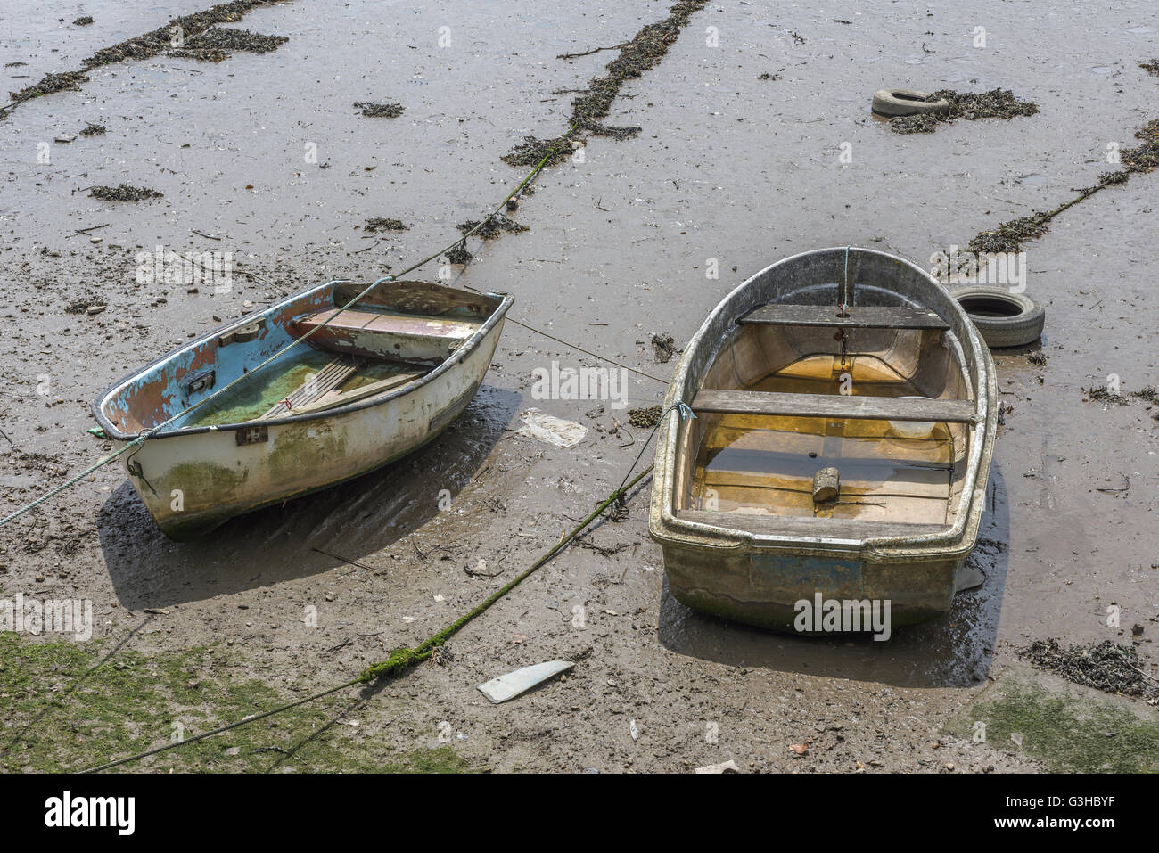 Beached two old rowing boats as a visual metaphor for 'washed up ...