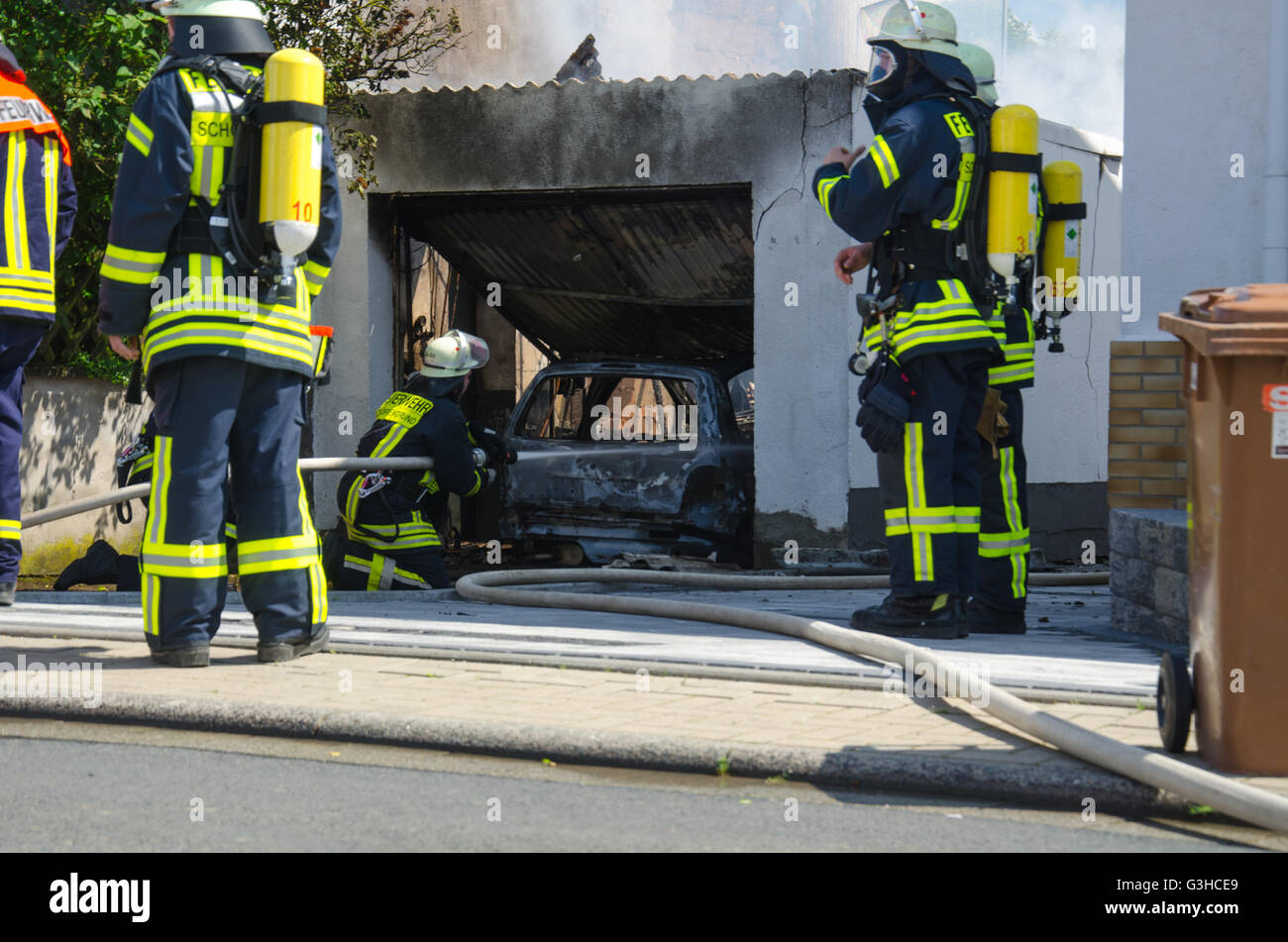 Firefighters extinguishing a burning garage Stock Photo - Alamy