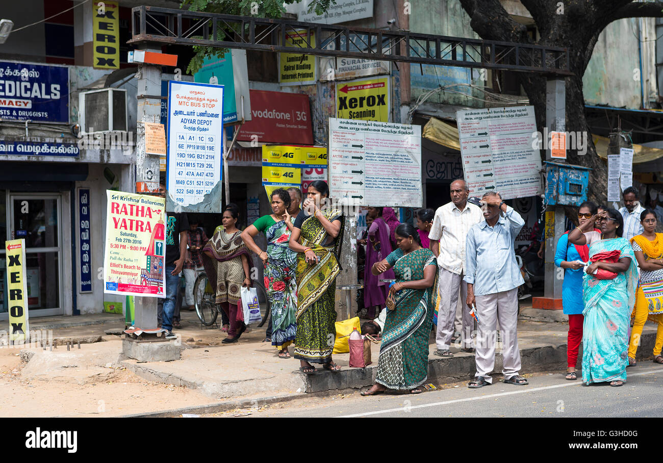 A group of Indian people waiting for a local bus in Mylapore, Chennai ...