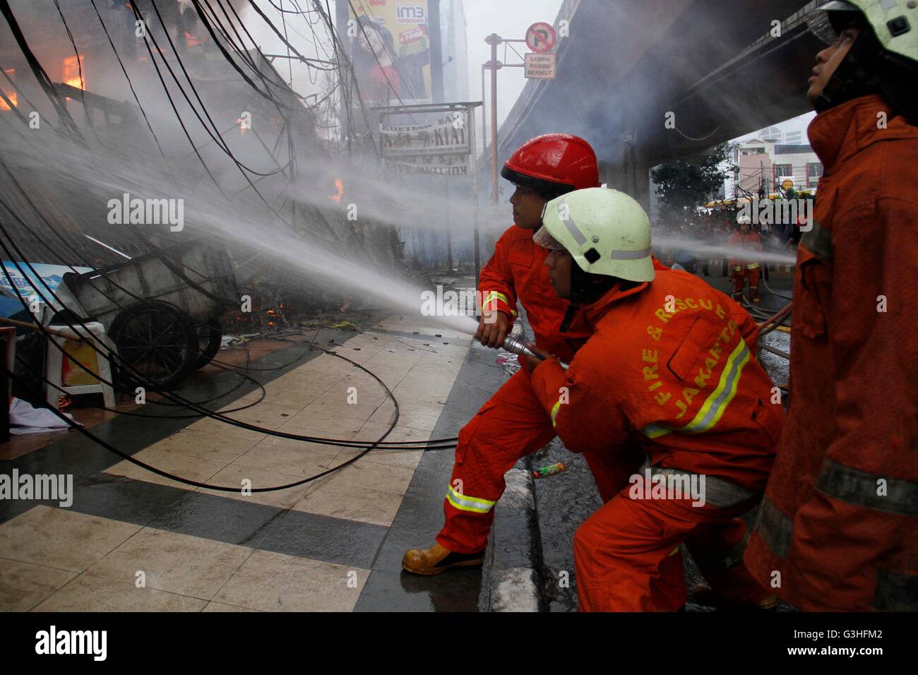 Jakarta, Indonesia. 17th Apr, 2016. Firefighter uses a fire hose to put ...