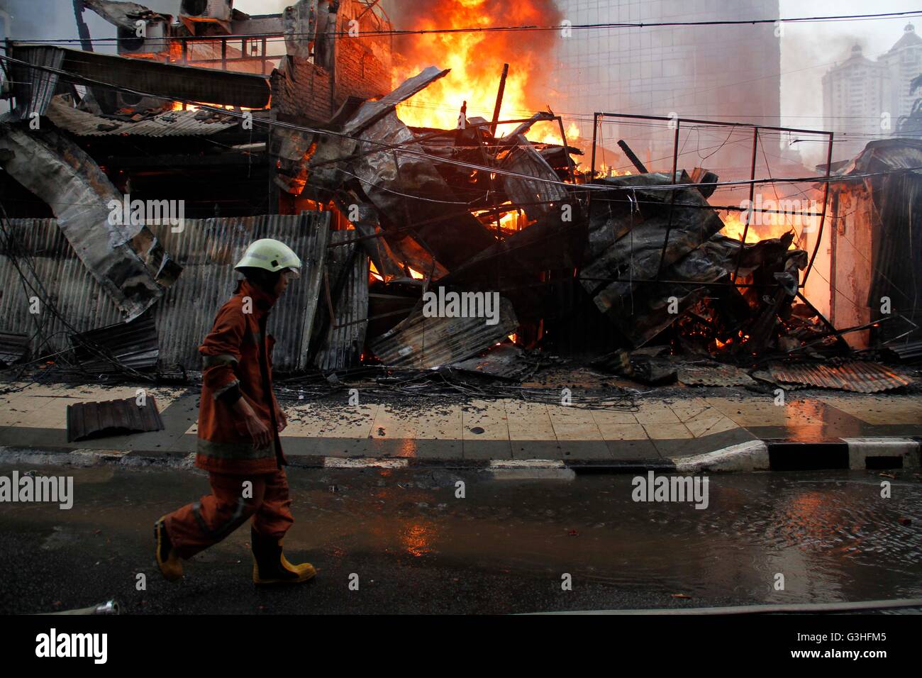 Jakarta, Indonesia. 17th Apr, 2016. A firefighter walks through the ...