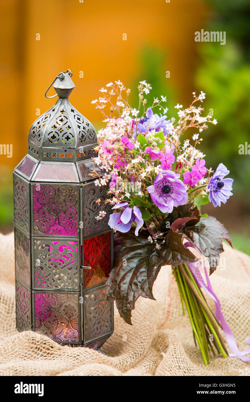 Garden style summer bouquet. Mix of lilac and purple anemone flowers ...