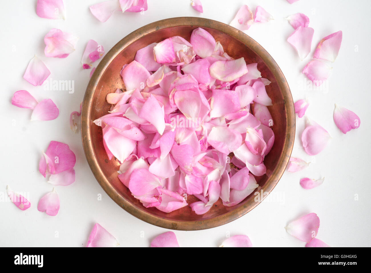 Pink rose petals in a copper plate Stock Photo - Alamy