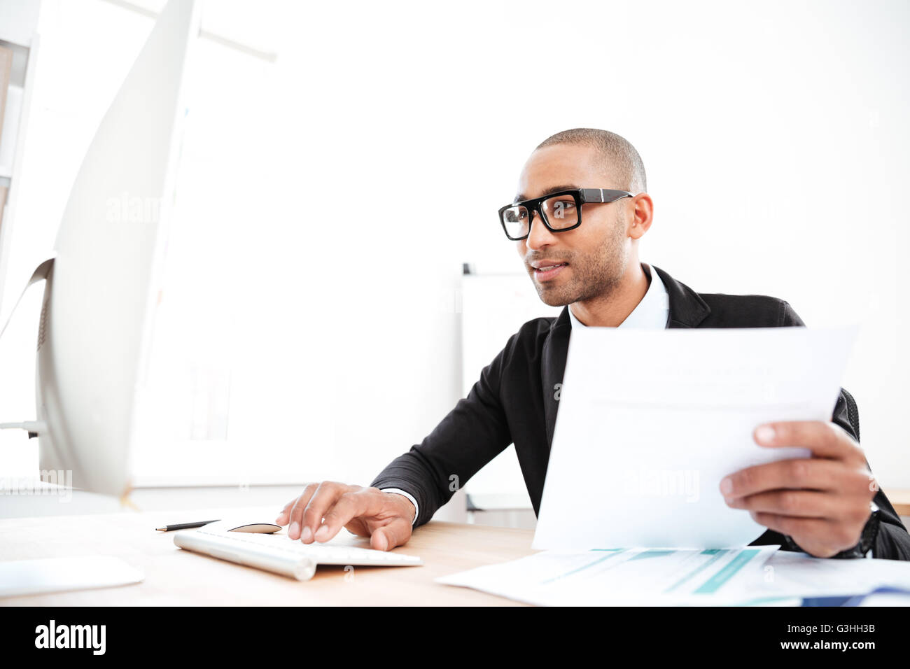 Young businessman comparing checking documents hi-res stock photography ...