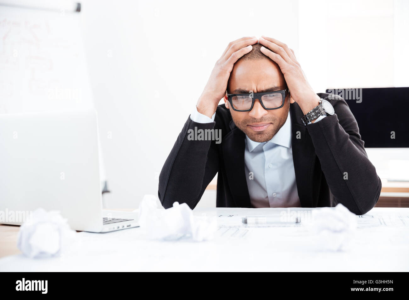 Business man in stress or depression sitting at the desk on office ...