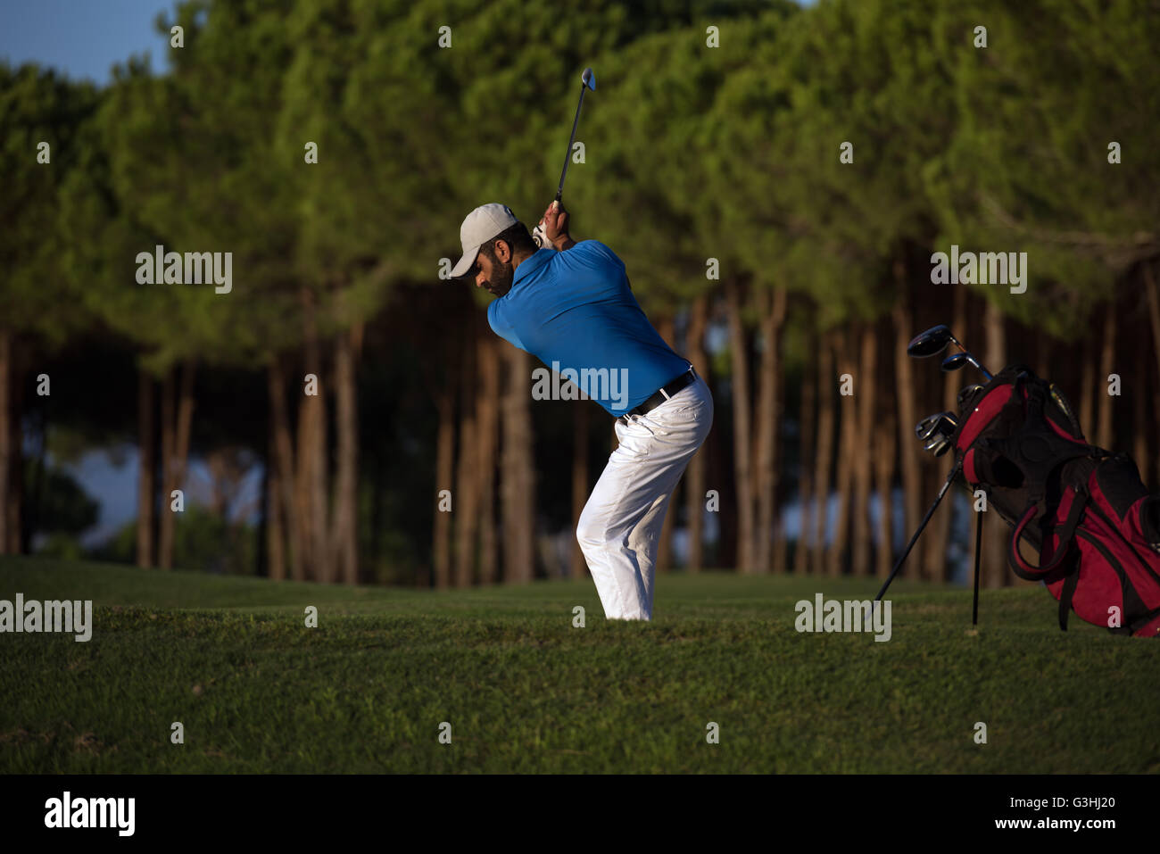 golfer shot ball from sand bunker at golf course with beautiful sunset ...