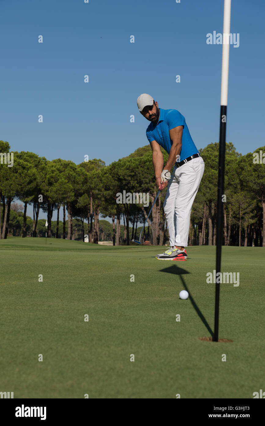 golf player hitting shot with driver on course at beautiful sunny day ...