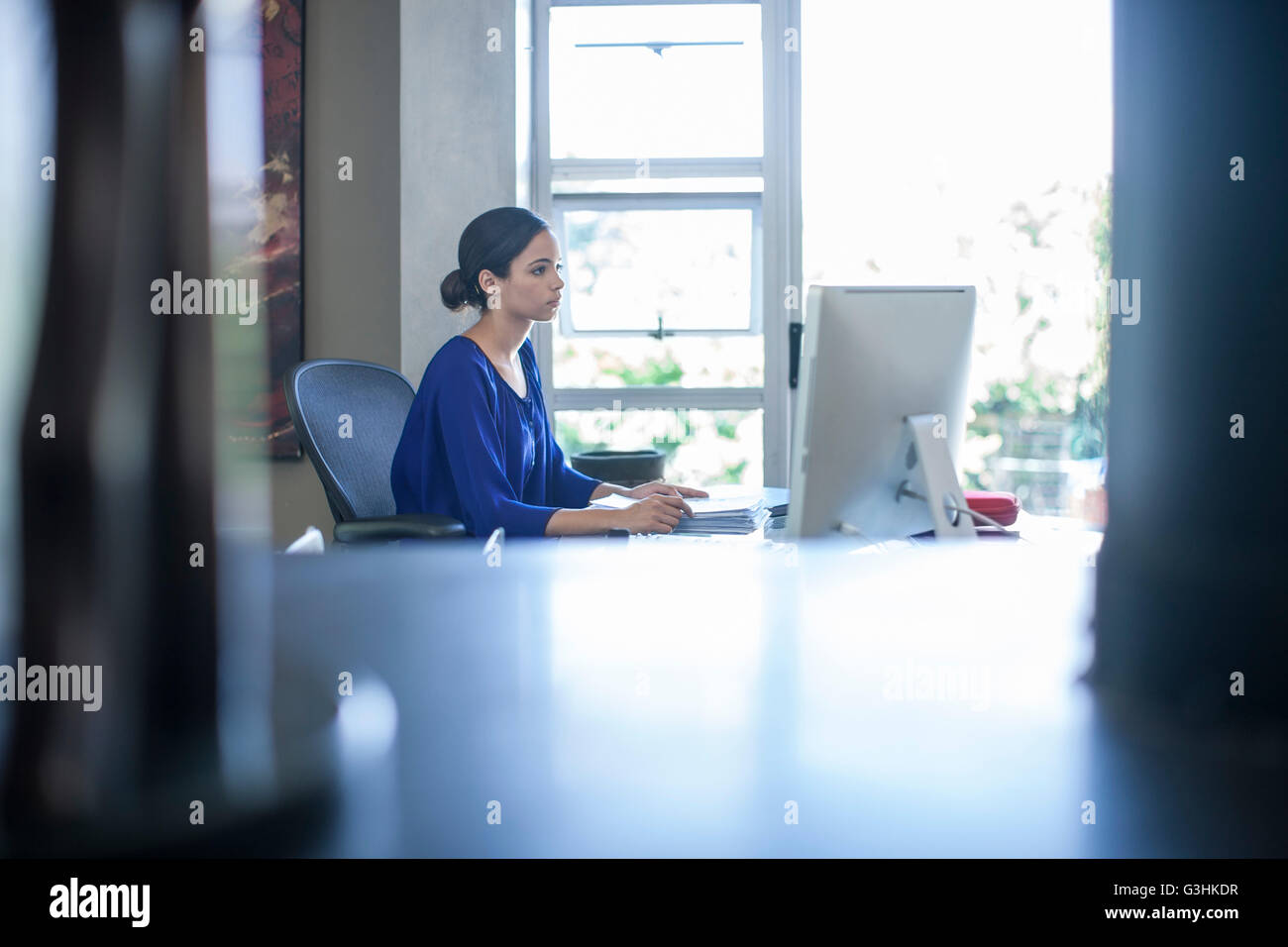 Young female designer working on computer in design office Stock Photo ...