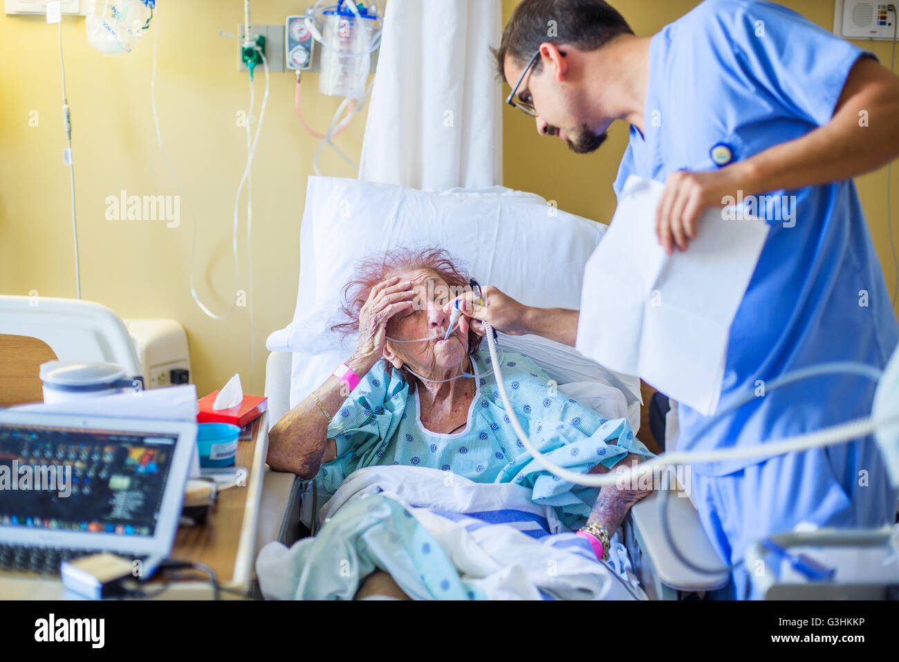 Hospital staff checking on patient on hospital bed Stock Photo - Alamy