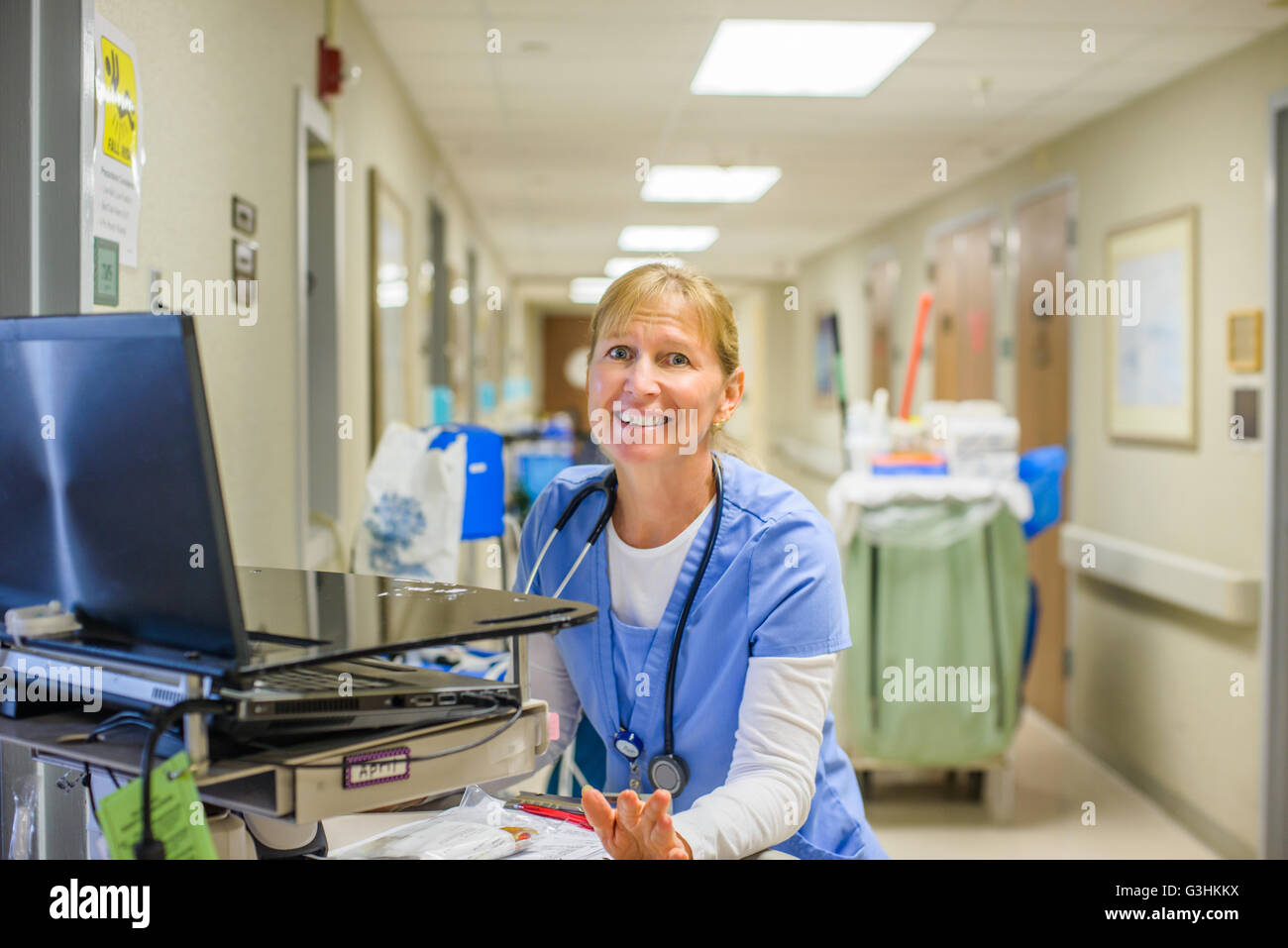 Hospital staff using computer for analysing and monitoring patient ...