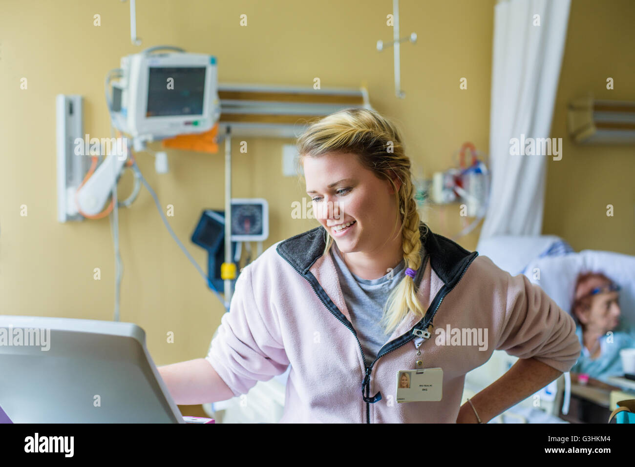 Hospital staff using computer for analysing and monitoring patient ...