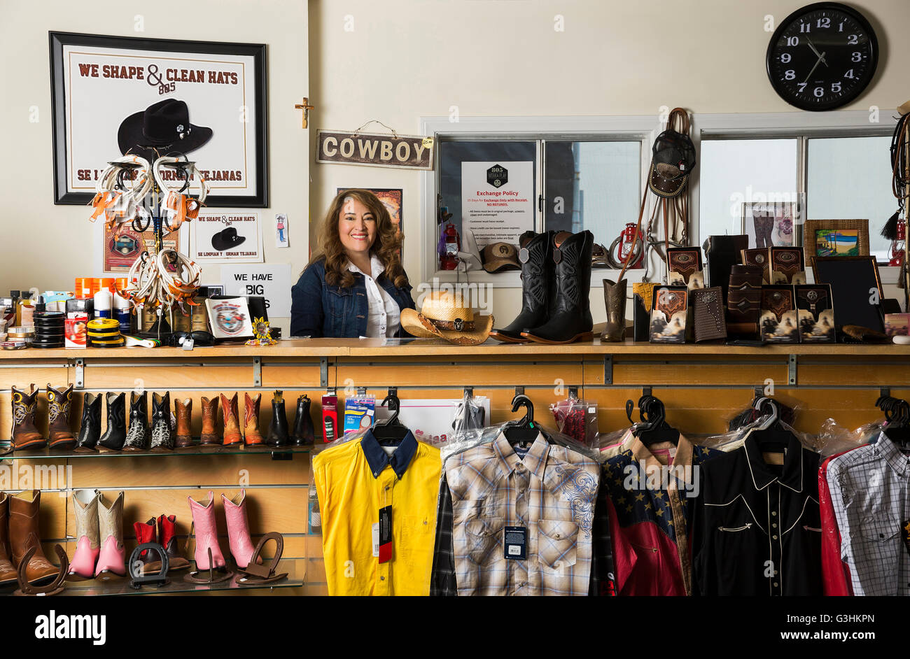 Shop assistant behind service counter Stock Photo - Alamy