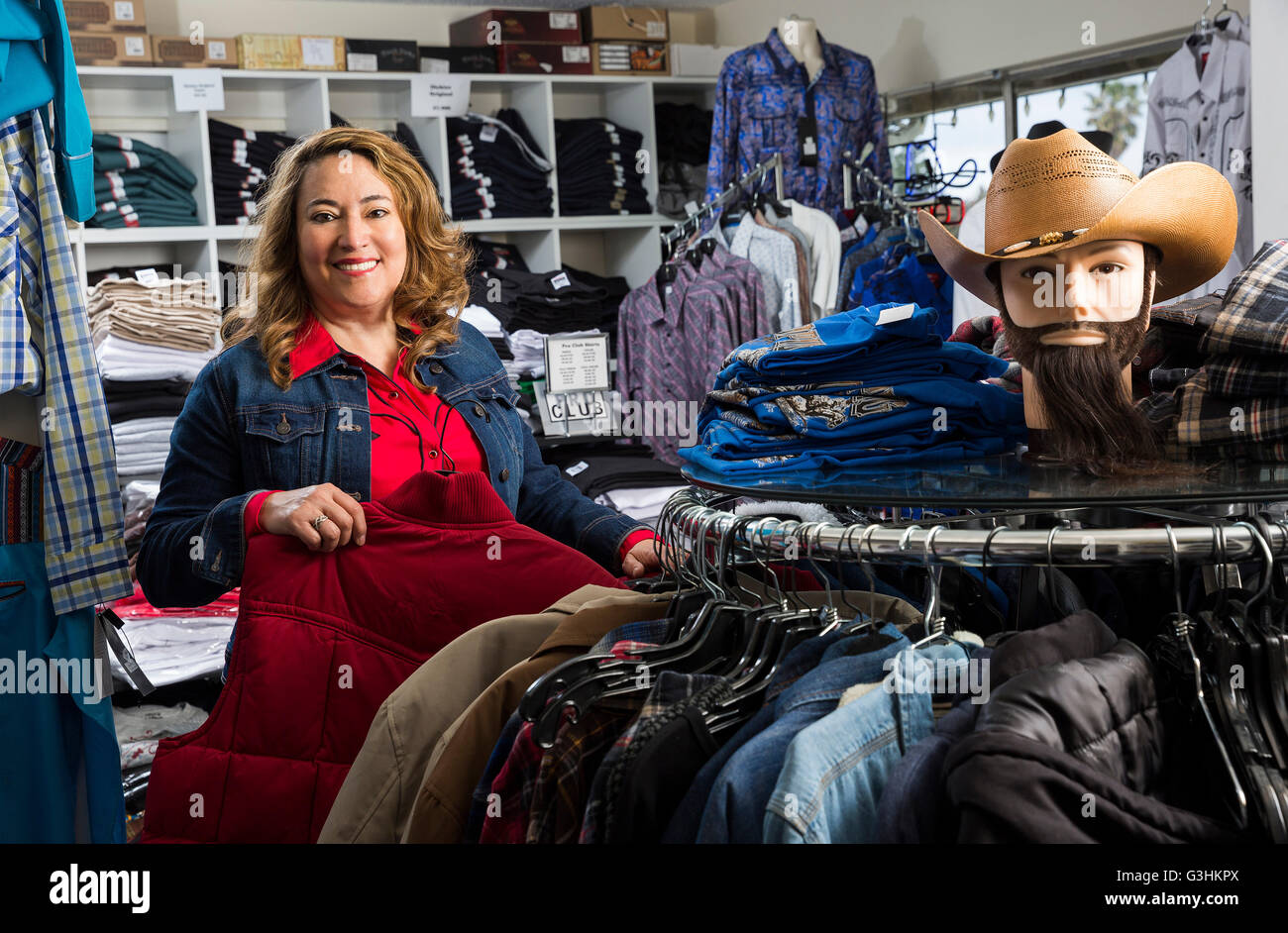 Shop assistant in clothing shop Stock Photo - Alamy
