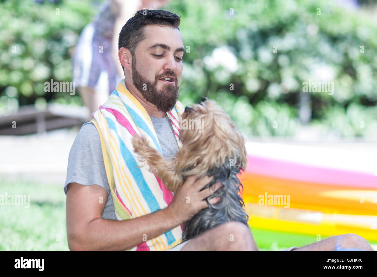 Man playing with pet dog in garden Stock Photo - Alamy