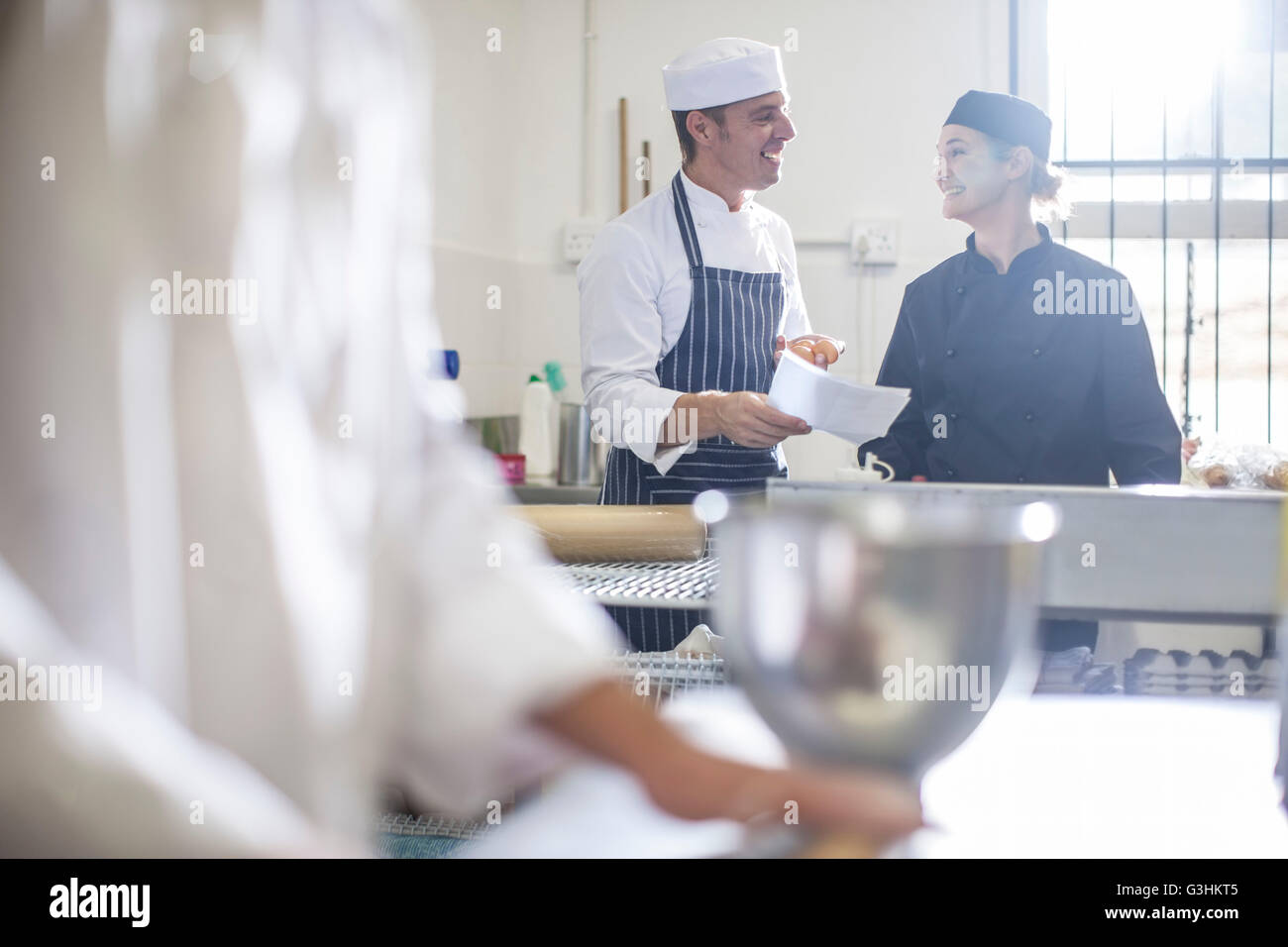 Chefs chatting in kitchen Stock Photo - Alamy
