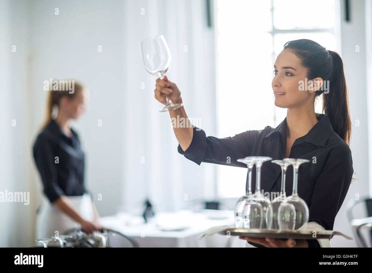 Smiling waitress setting table hi-res stock photography and images - Alamy